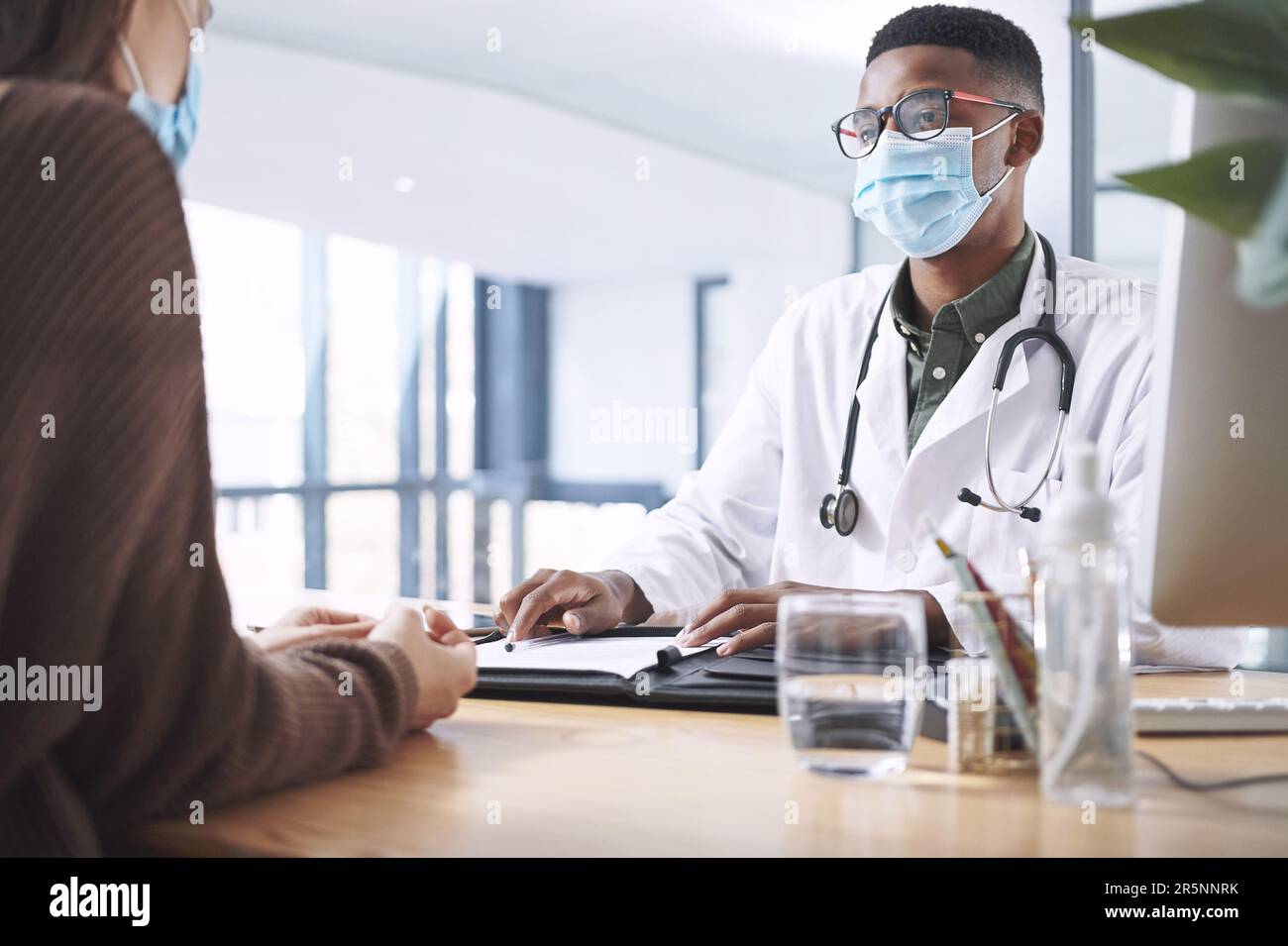 Are you ready to continue. a young doctor sitting with his patient and ...