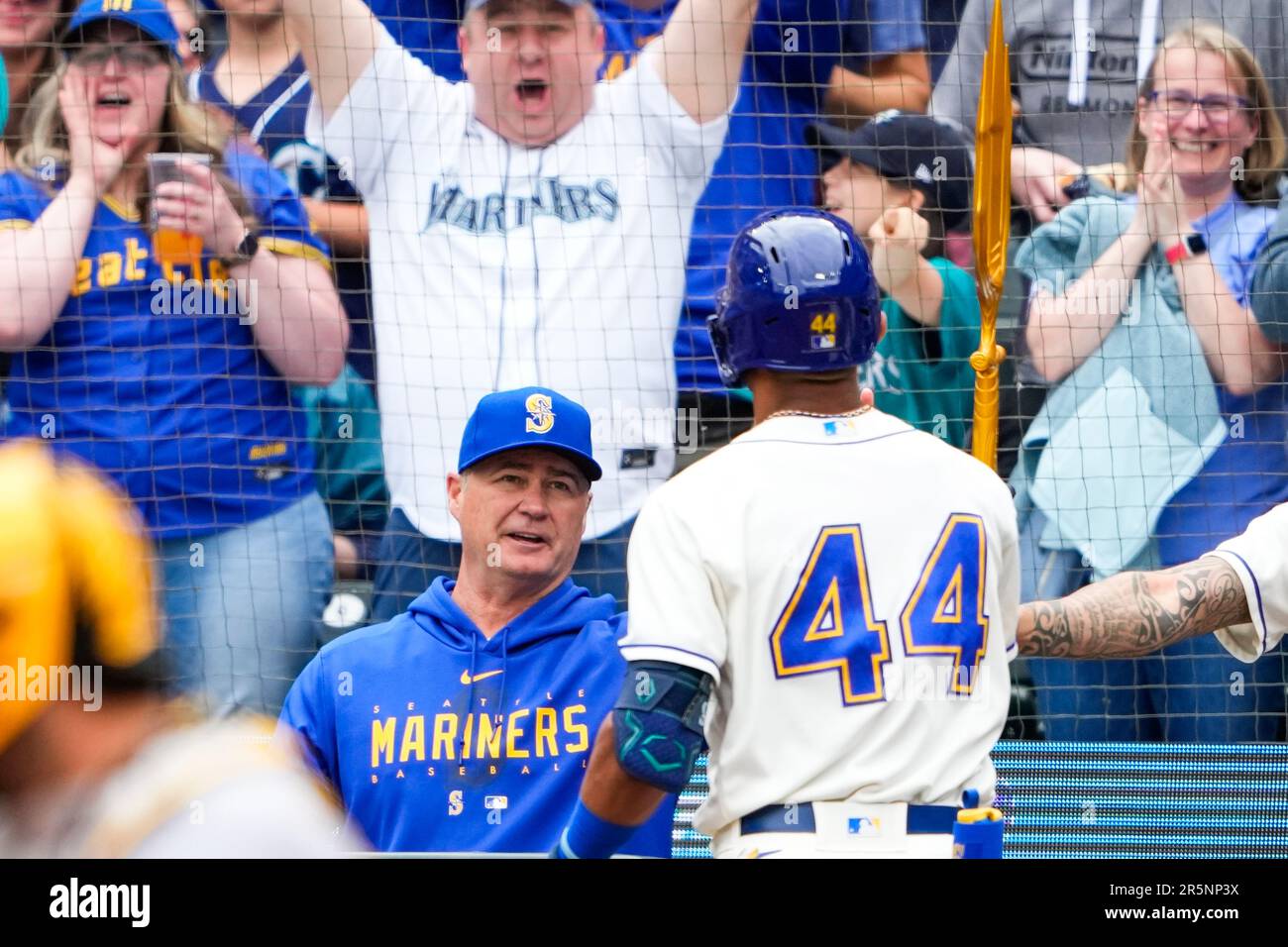 Seattle Mariners' Julio Rodriguez holds a trident while greeting ...
