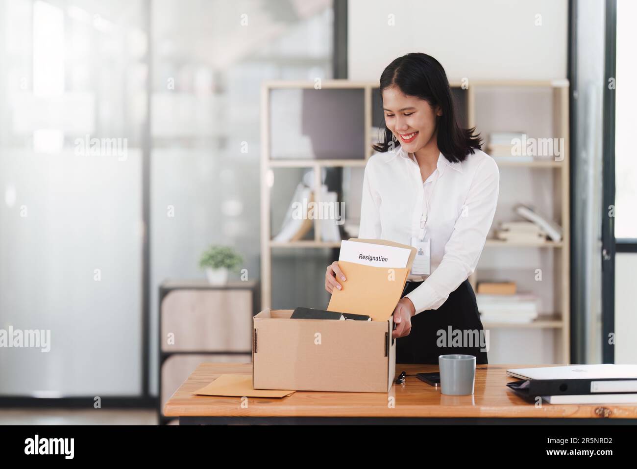 Resignation concept. Employee holding box of belongings in an office ...