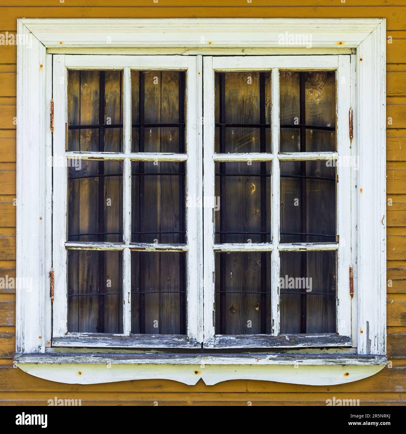 White painted wooden window pane on an old wooden building on ...