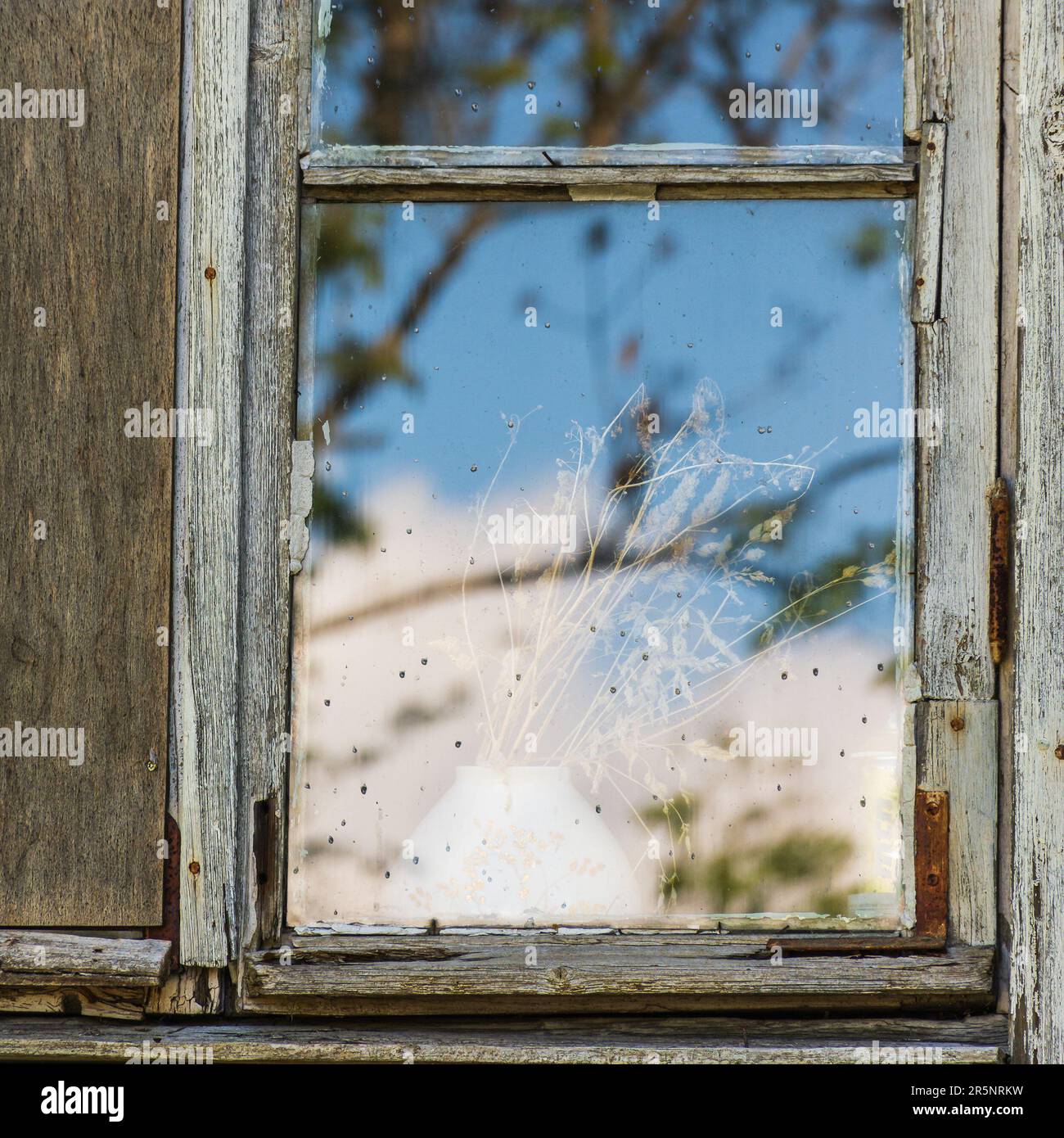 White painted wooden window pane on an old wooden building on ...