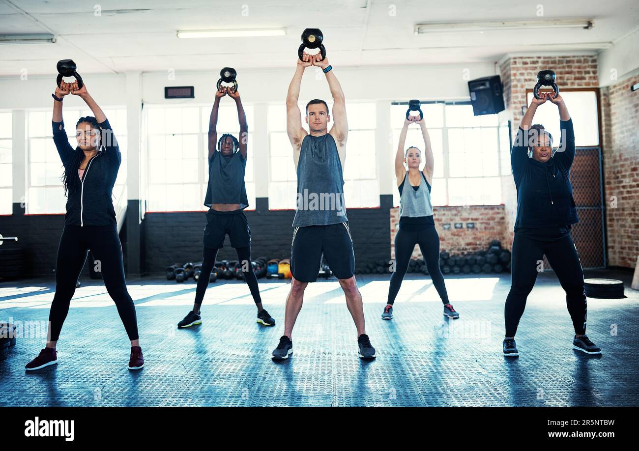 Give group dynamics a try. a fitness group using kettle-bells in their ...