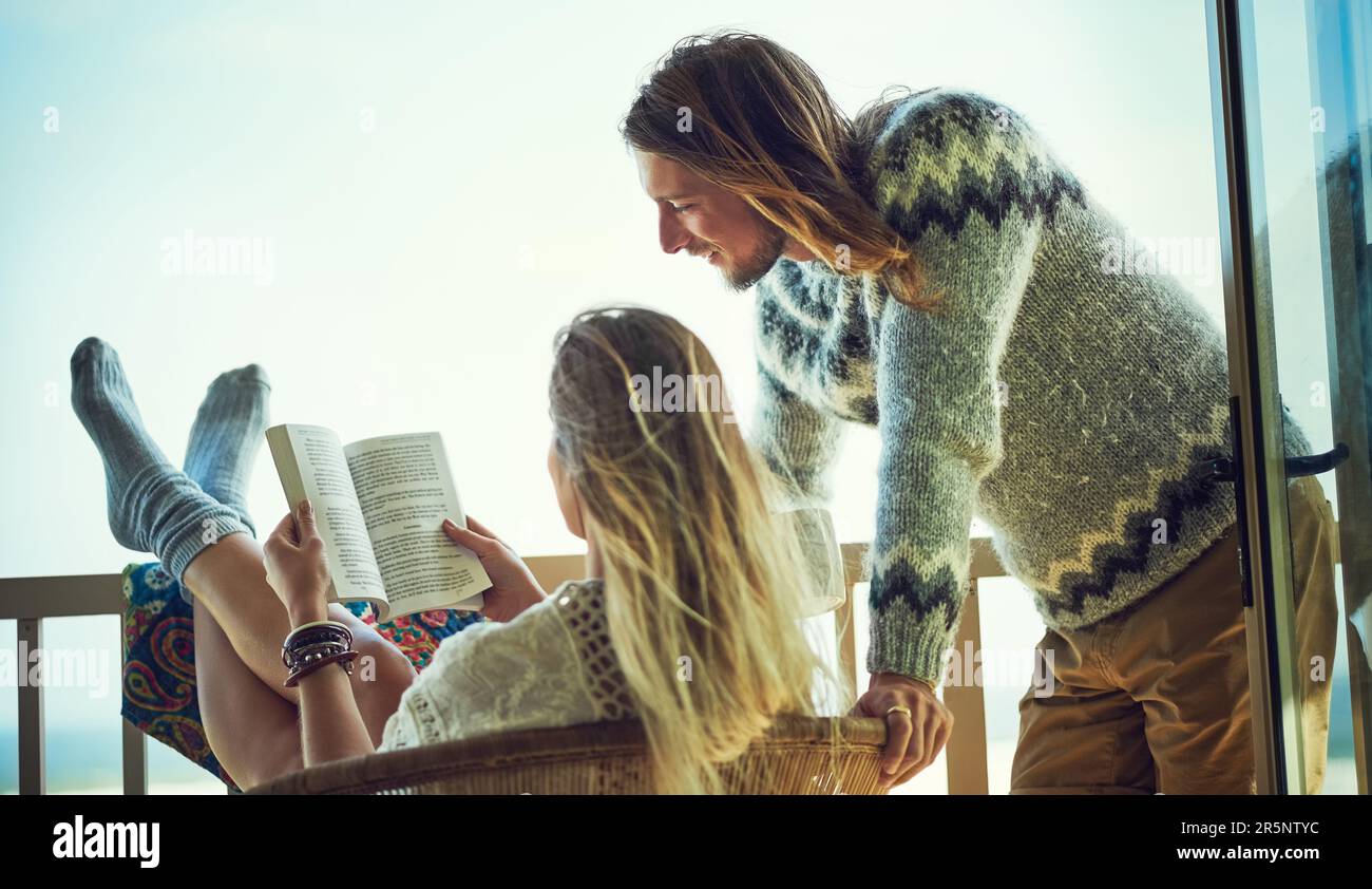 Couples who read together. a young couple reading a book together while ...