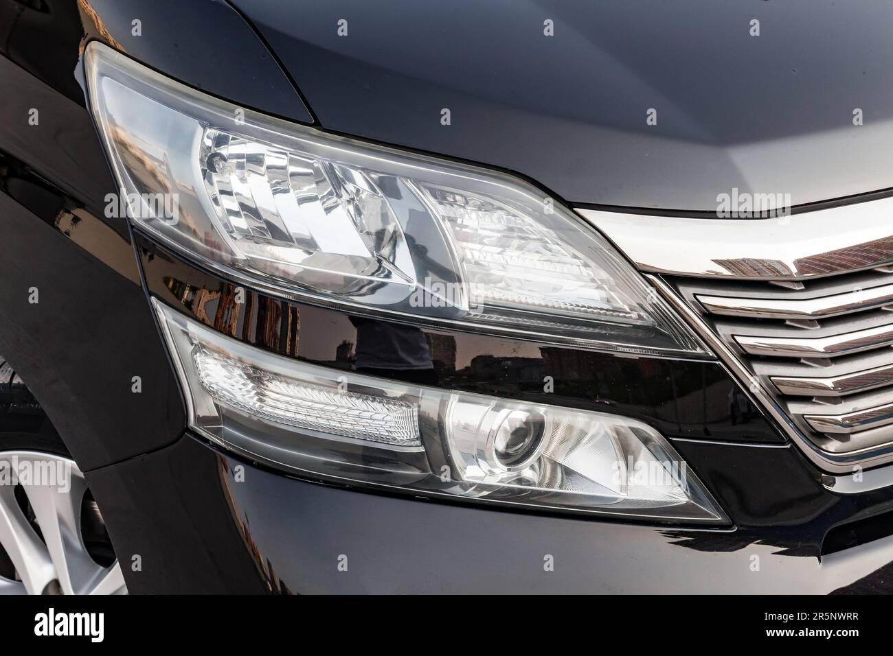 Front headlight view of car in black color after cleaning and detailing ...