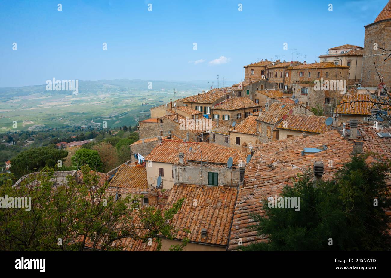 Characteristic terracotta rooftops of walled city of Volterra and ...