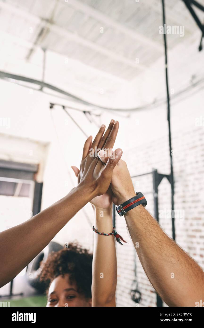 We can do this. three sporty young people giving each other a high five ...