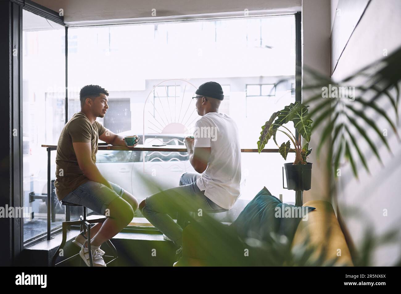 Want to do this again. two young men talking while having coffee together in a cafe Stock Photo ...