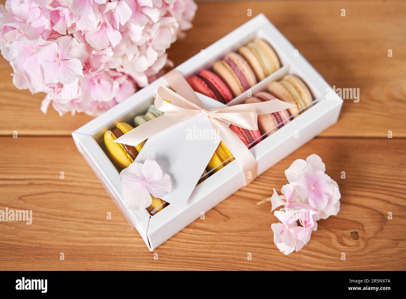 Dessert French Macarons in present box. Sweet dessert on a flowers ...