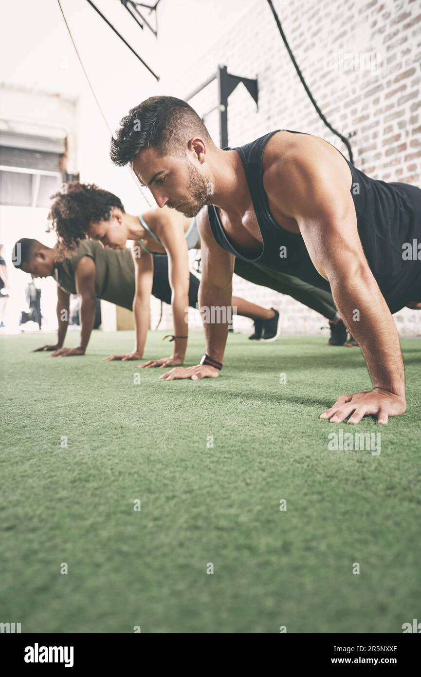 We started simple and worked our way up. a fitness group doing push-ups ...