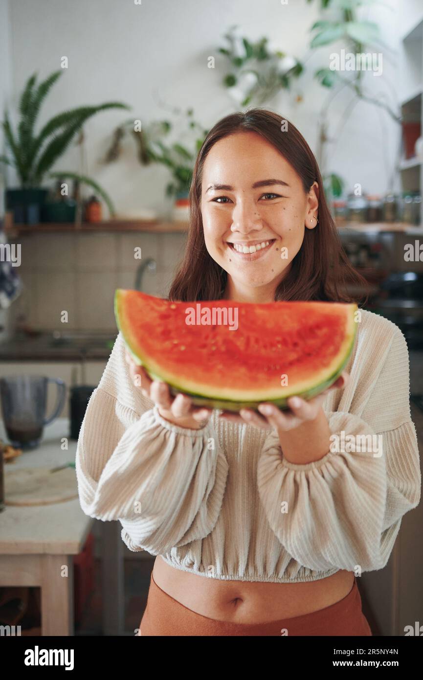 Water melon is my favourite fruit. a young woman holding some ...