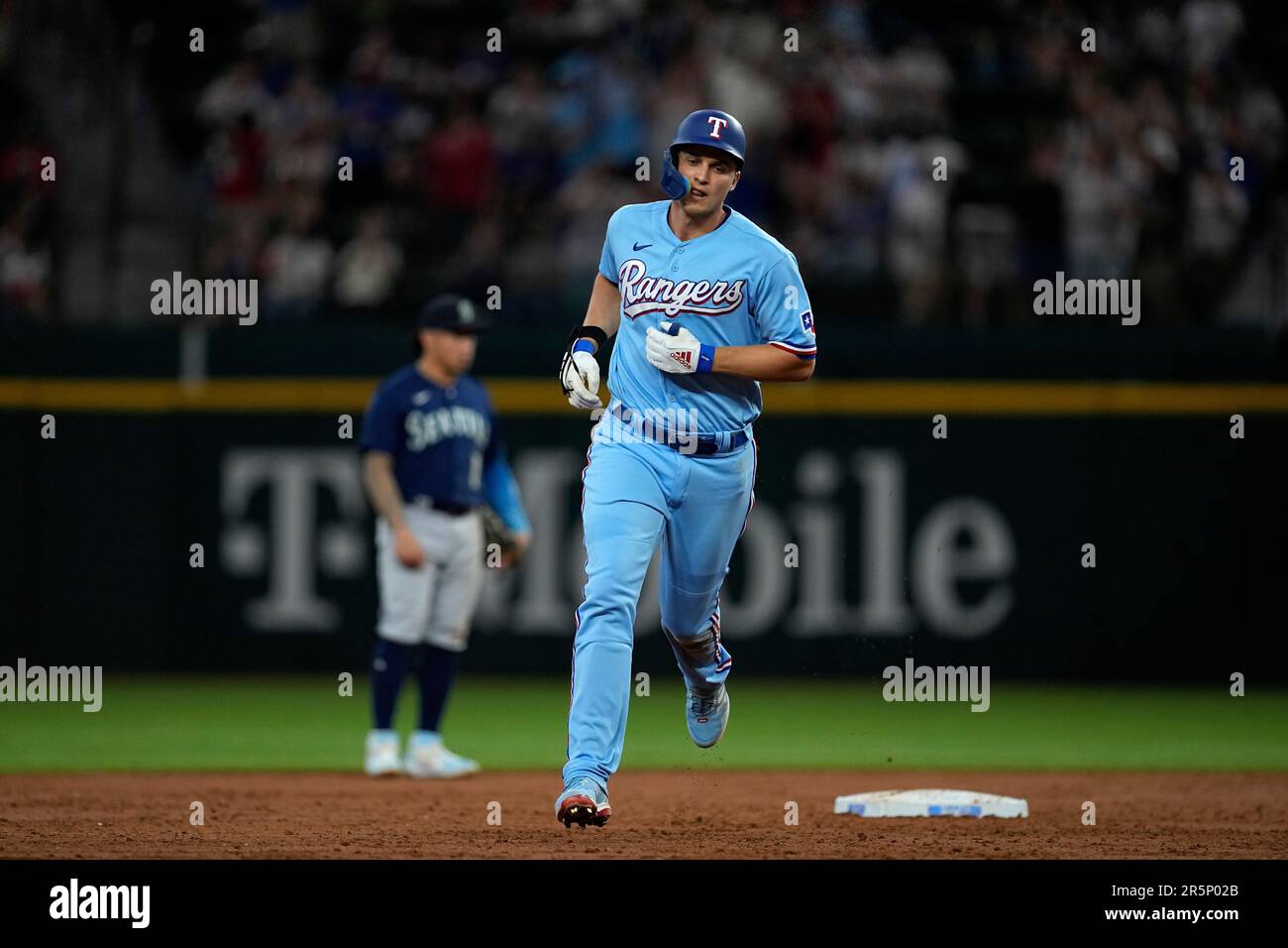 Texas Rangers' Corey Seager rounds the bases after hitting a home run during a baseball game ...
