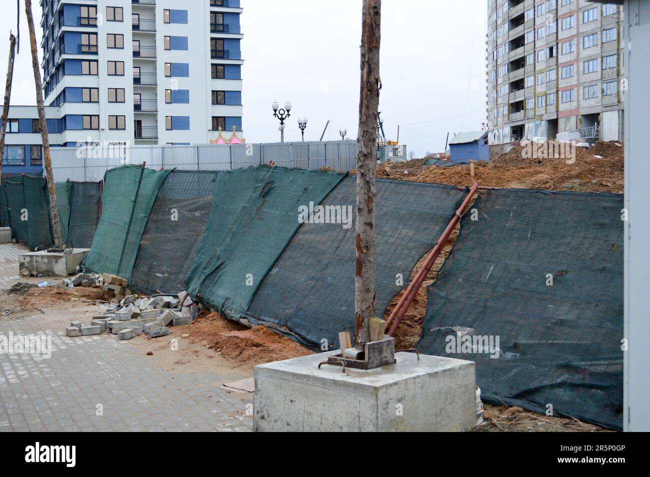 A mess at a construction site with scattered building materials and ...