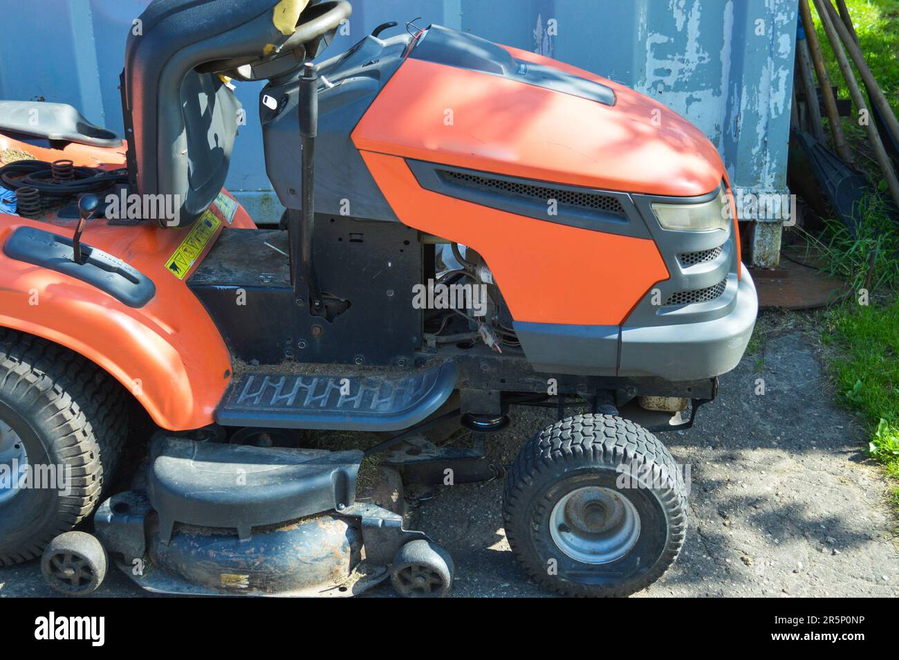 New modern red four-wheel lawn mower for mowing grass, lawn ...