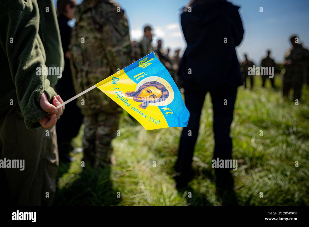 A religious flag in Ukrainian colours is held during a field briefing ...