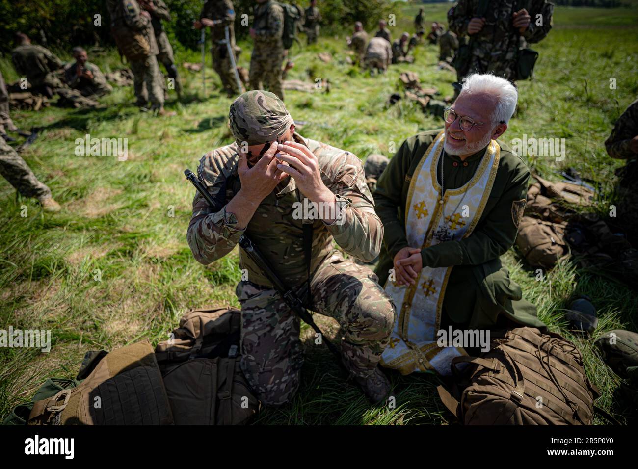 Ukrainian military chaplain 2nd Lieutenant Genadij Rohmanijko, watches ...