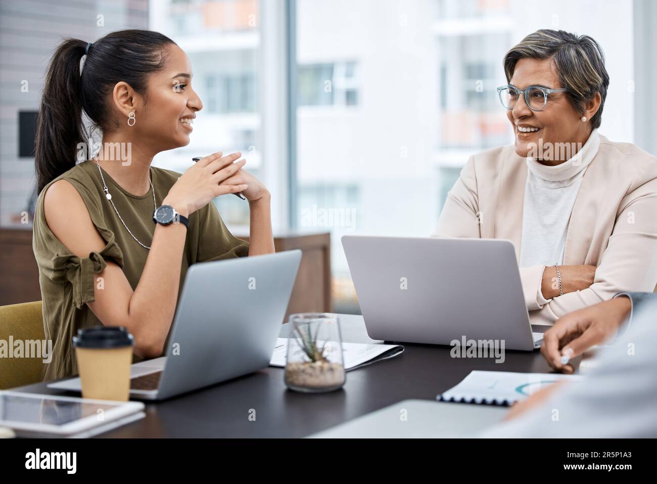 Laptop, business and meeting with mentor coaching happy employee in an office planning a ...