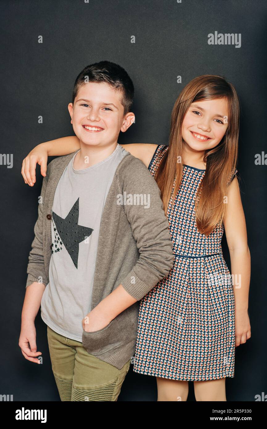 Studio portrait of two cute kids, posing on black background Stock ...