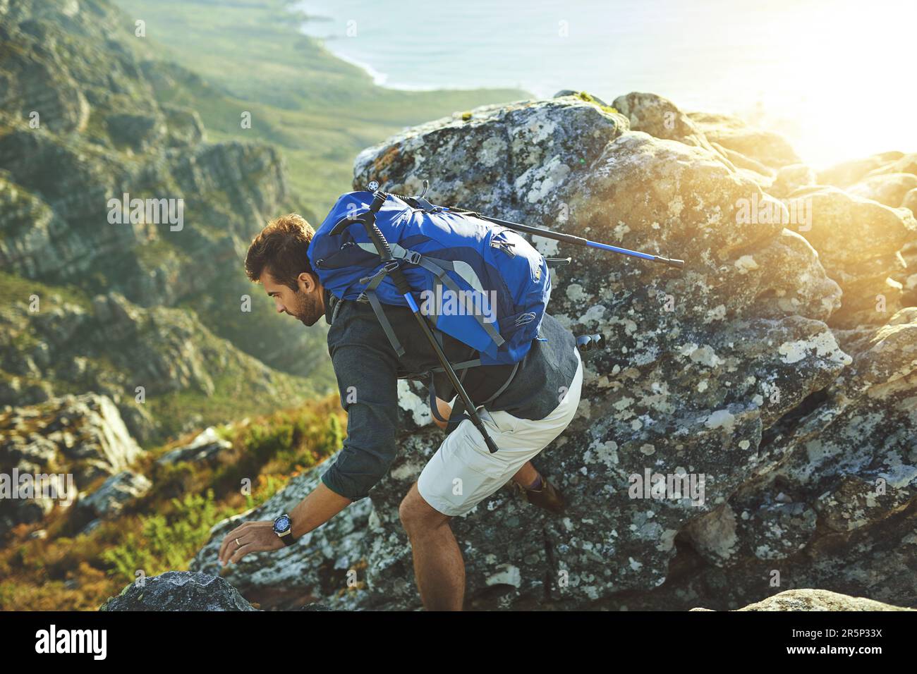 What goes up must come down. a young man hiking up a mountain Stock ...