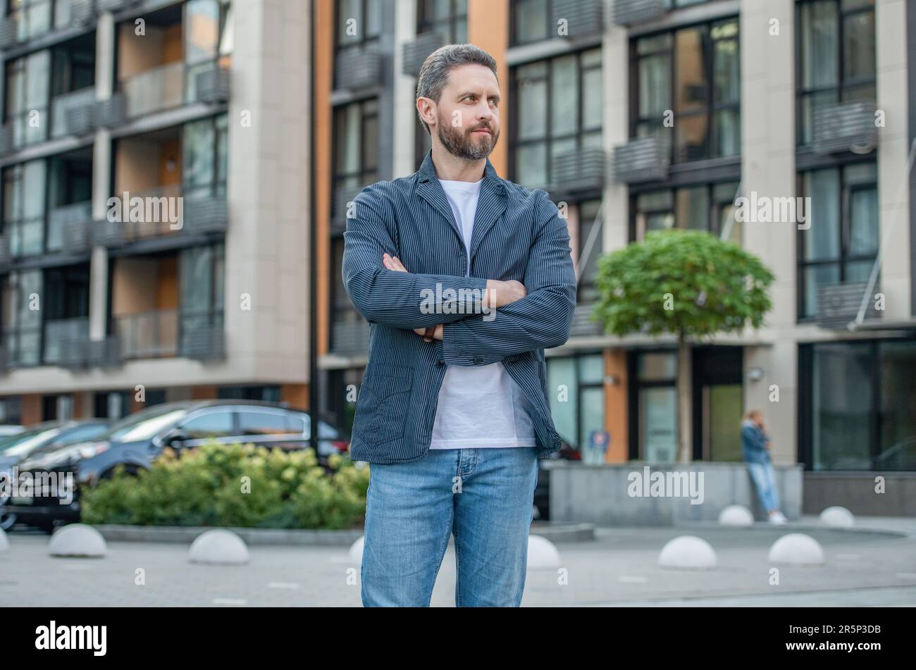 caucasian guy crossing hands outdoor. caucasian guy in the street ...