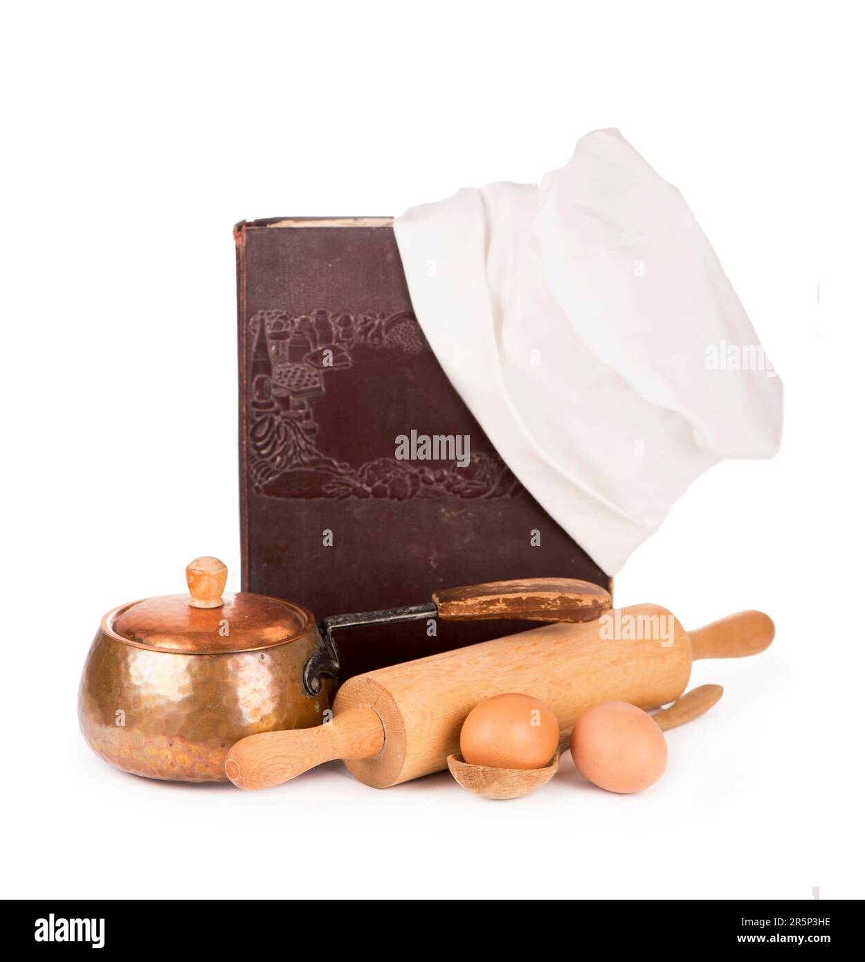 Chef's hat with battledore and cook book on white background Stock ...