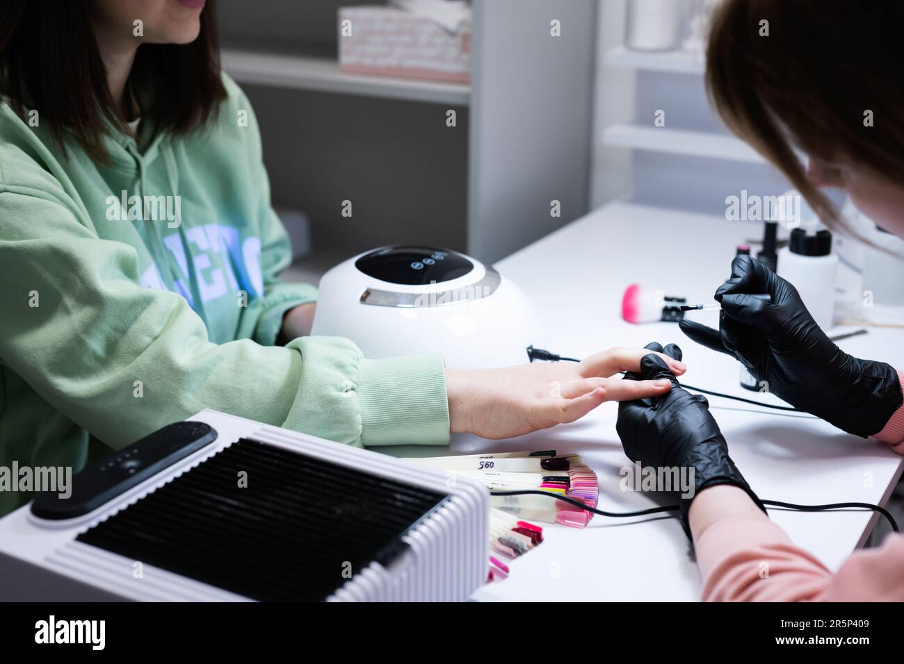 Woman makes manicure client hi-res stock photography and images - Alamy