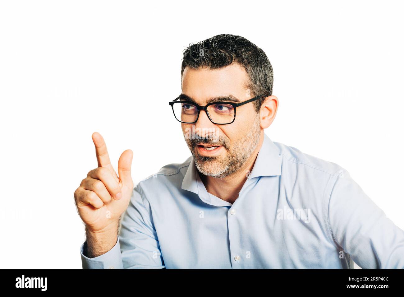 Studio portrait of handsome man wearing formal blue shirt and glasses ...