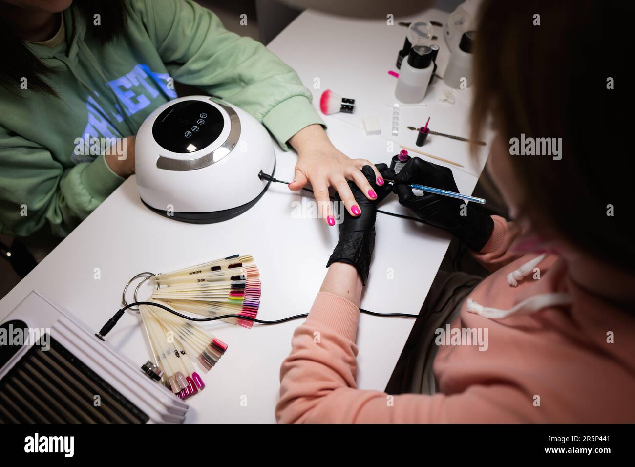 Woman makes manicure client hi-res stock photography and images - Alamy