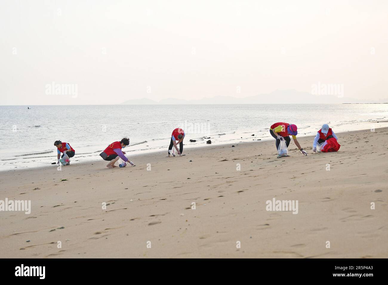 YANTAI, CHINA - JUNE 5, 2023 - Volunteers pick up garbages at the ...