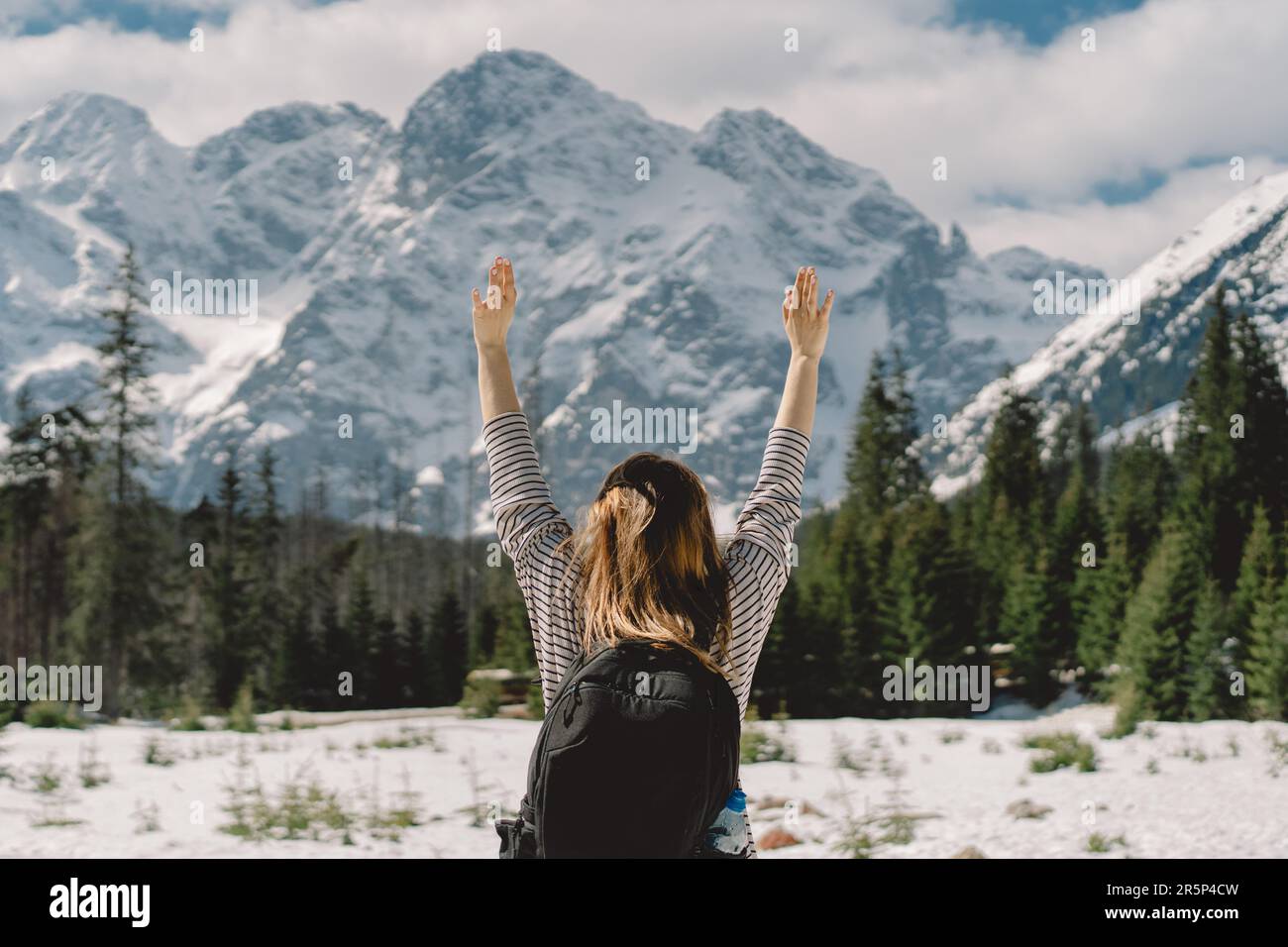Back view of a girl traveler wearing a backpack traveling alone Stock ...