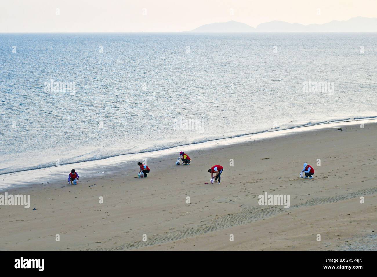 YANTAI, CHINA - JUNE 5, 2023 - Volunteers pick up garbages at the ...