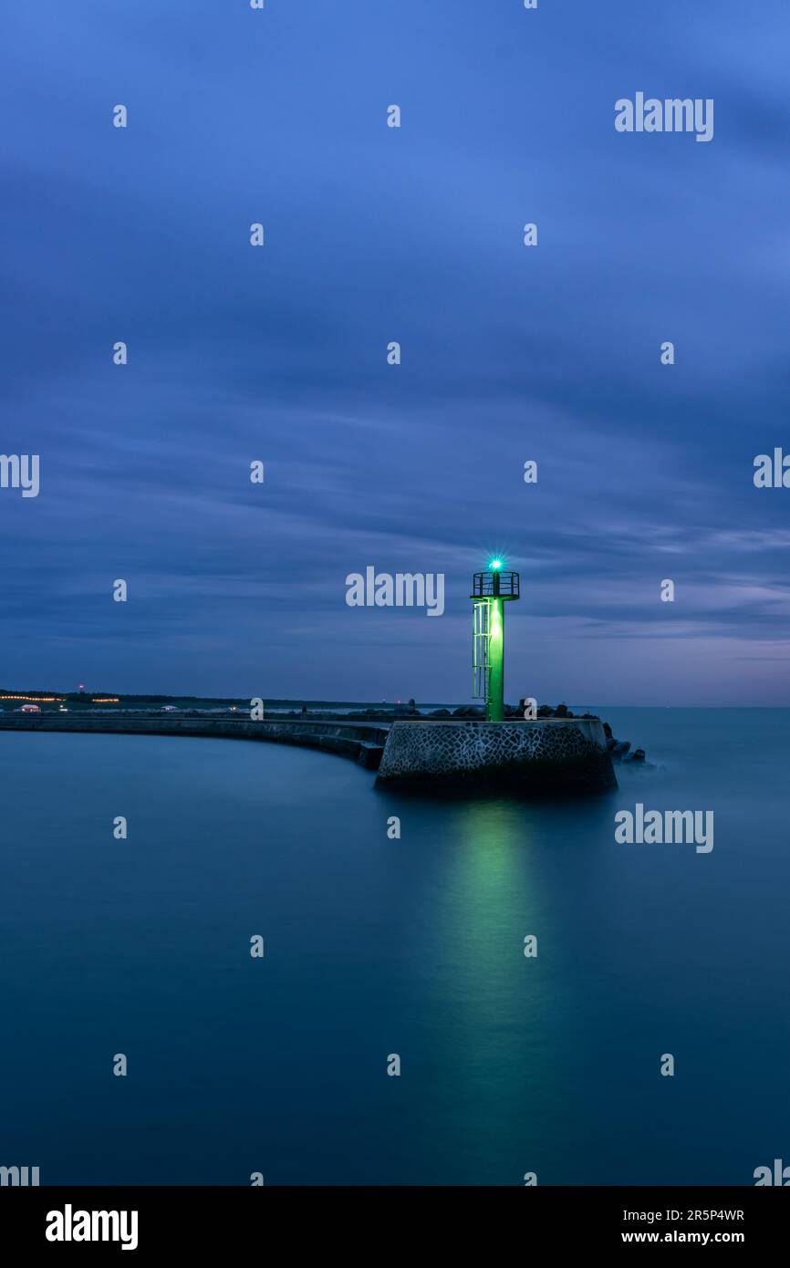 Stone pier in Darłowo in the evening. Lights on the beach. Traffic ...