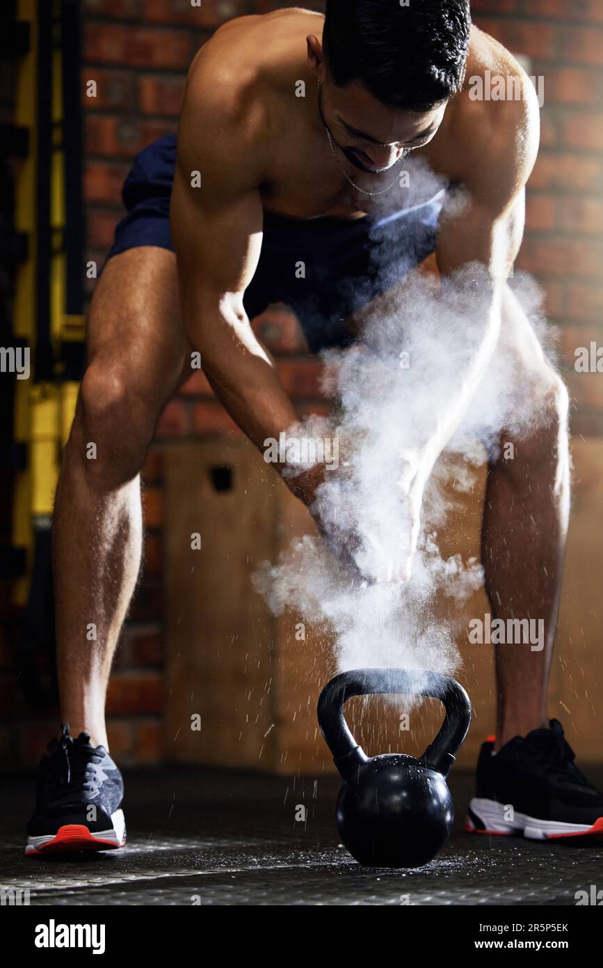 Powder, fitness and man with kettle bell in gym for exercise ...