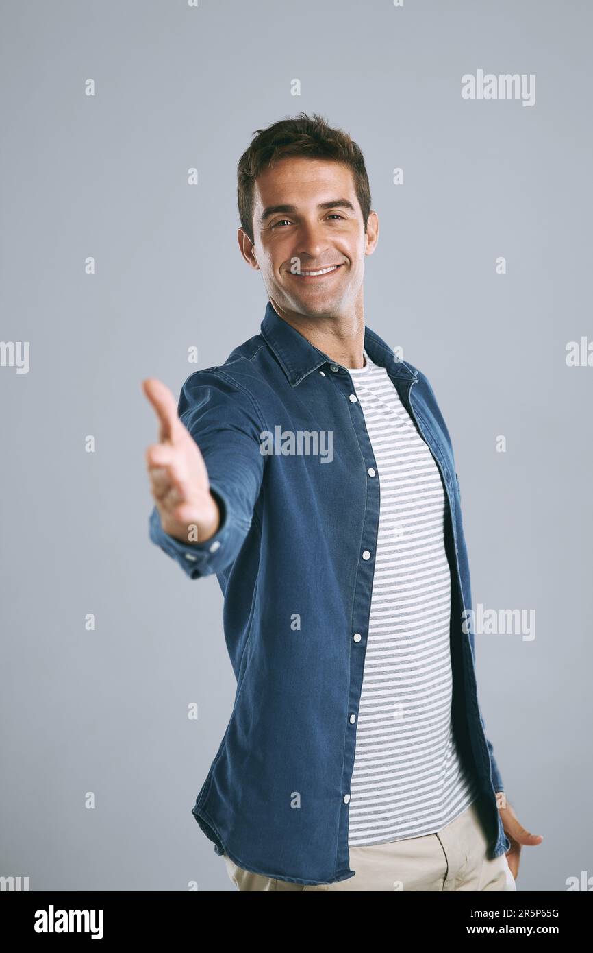 Lets shake hands. a handsome man reaching for a handshake Stock Photo ...