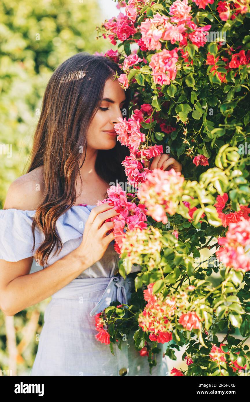 Woman smelling roses smile hi-res stock photography and images - Alamy