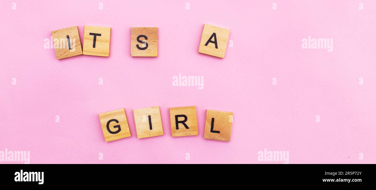 Word Its a girl by wooden cubes on a pink background. Symbol of ...