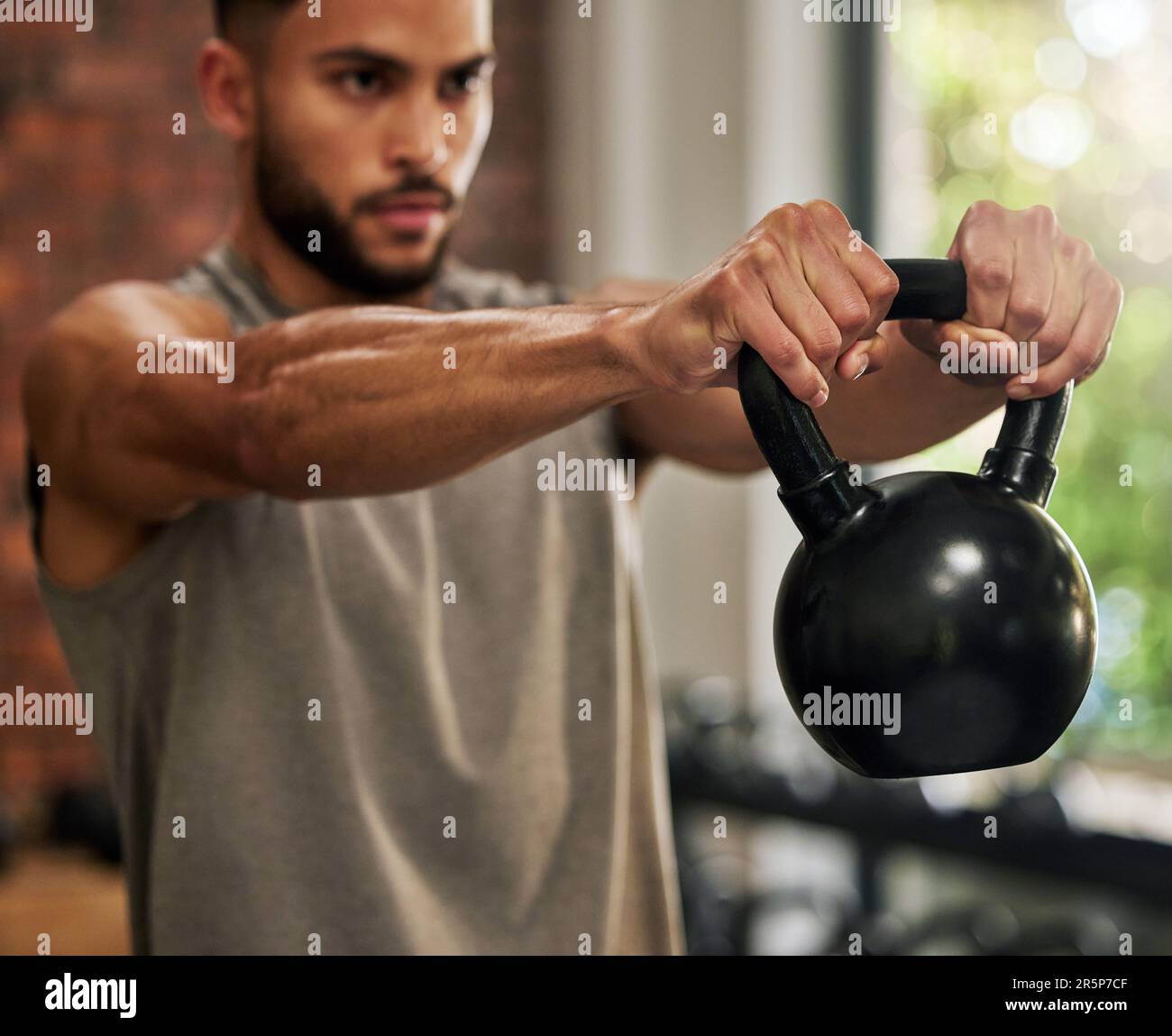 Fitness, training and man with kettle bell in gym for exercise ...