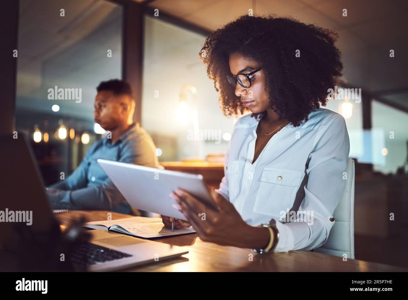 Working with her best productivity booster. a young businesswoman using ...