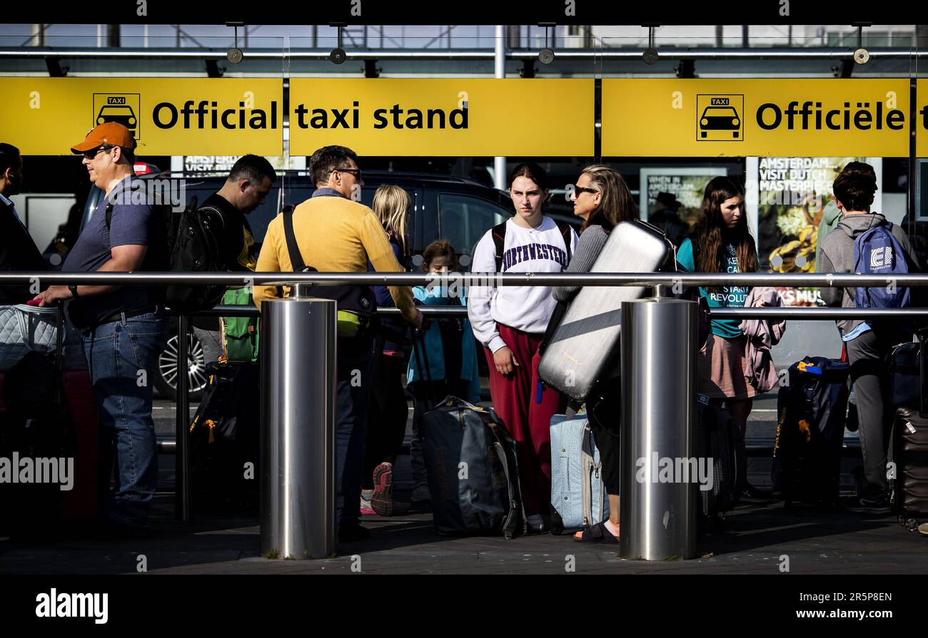 SCHIPHOL - Stranded travelers at Schiphol Airport wait at the official ...
