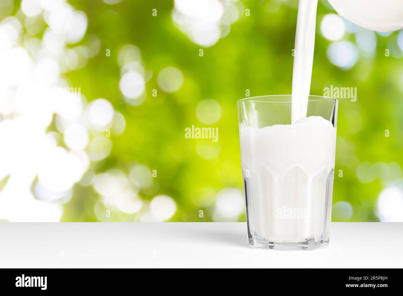 A glass of milk on a natural background Stock Photo - Alamy