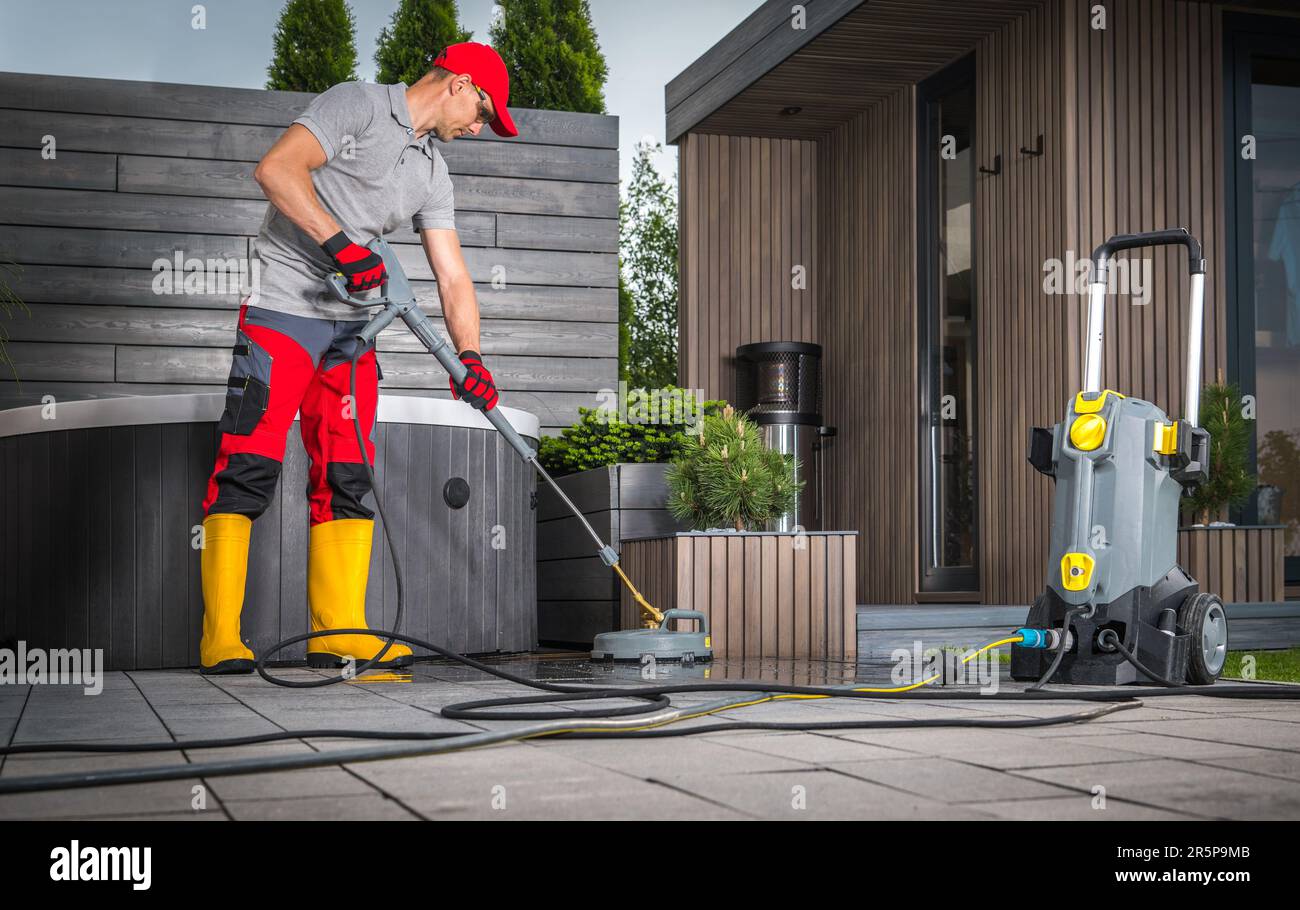 Caucasian Man in His 40s Pressure Washing Concrete Bricks Patio Using ...