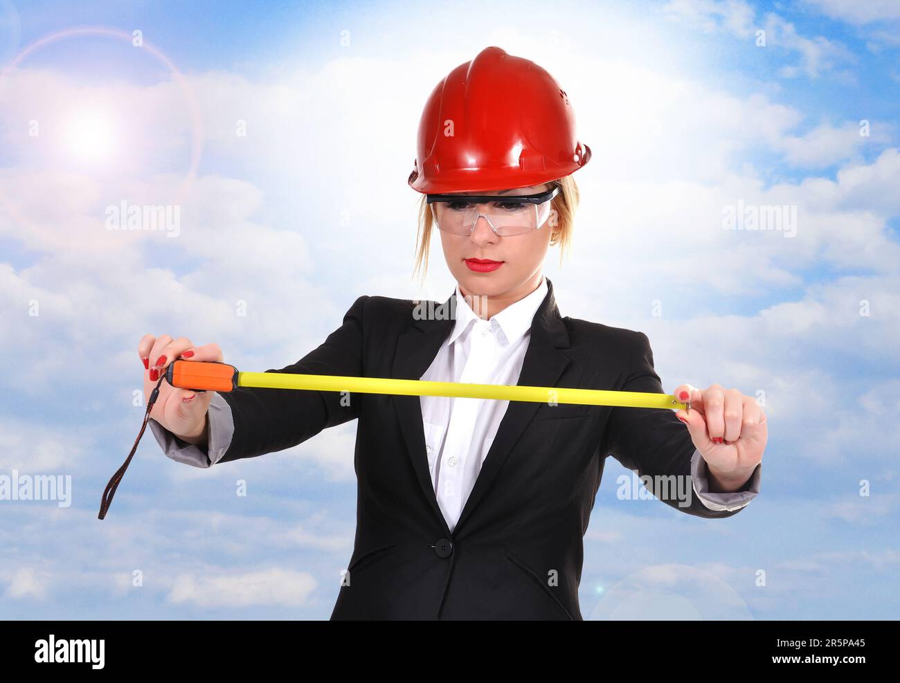 Engineer woman with ruler in hand on sky background Stock Photo - Alamy