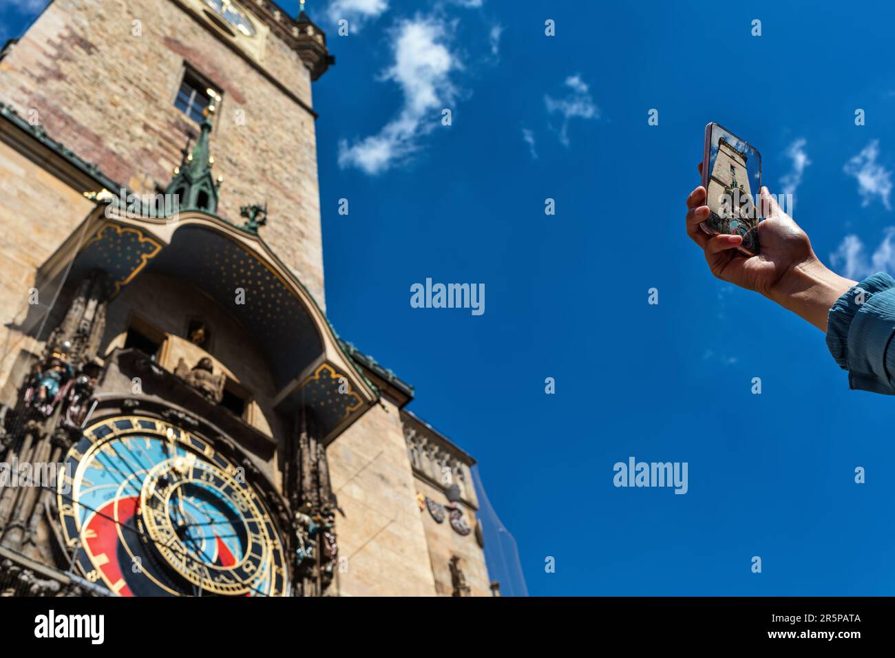 Unidentified person with a smartphone in the hand takes pictures of the ...