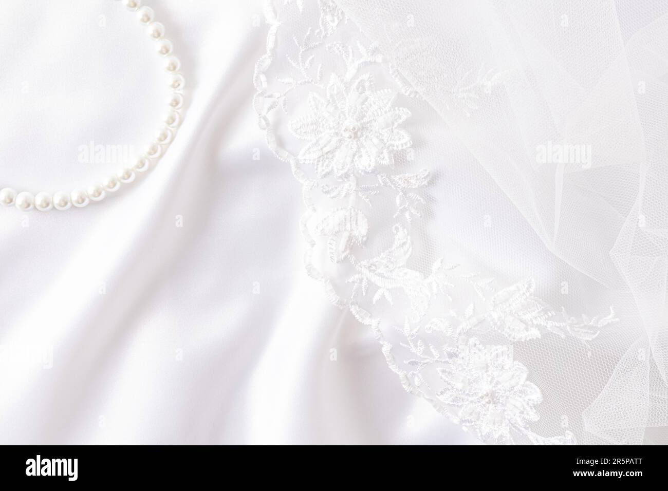 Chic wedding background for design. white satin fabric with soft waves, lace embroidered bridal ...