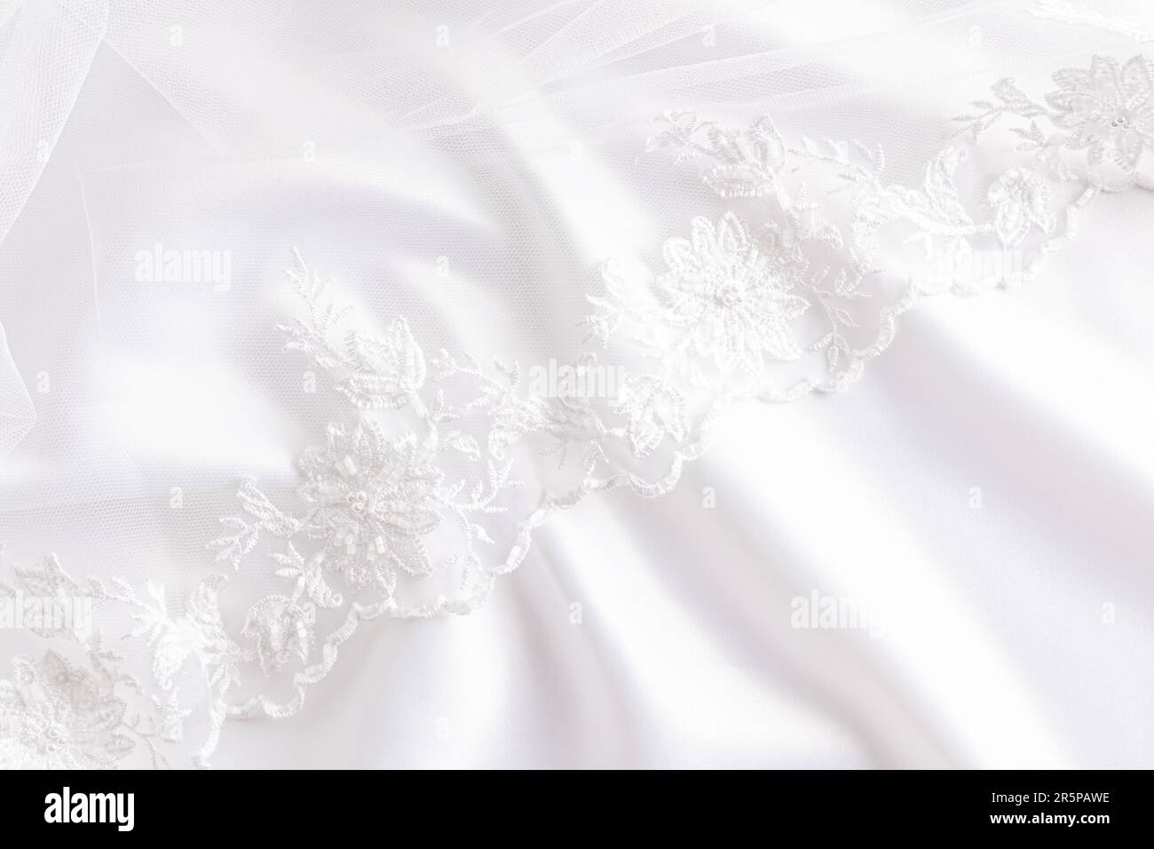 part of the bride's luxurious white embroidered veil on a satin white ...