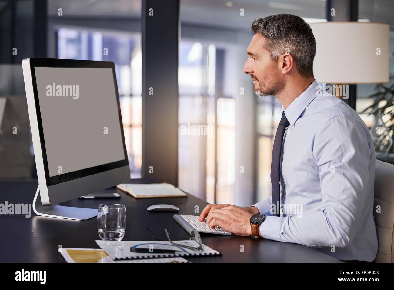Computer, email and report with a business man typing while sitting at ...