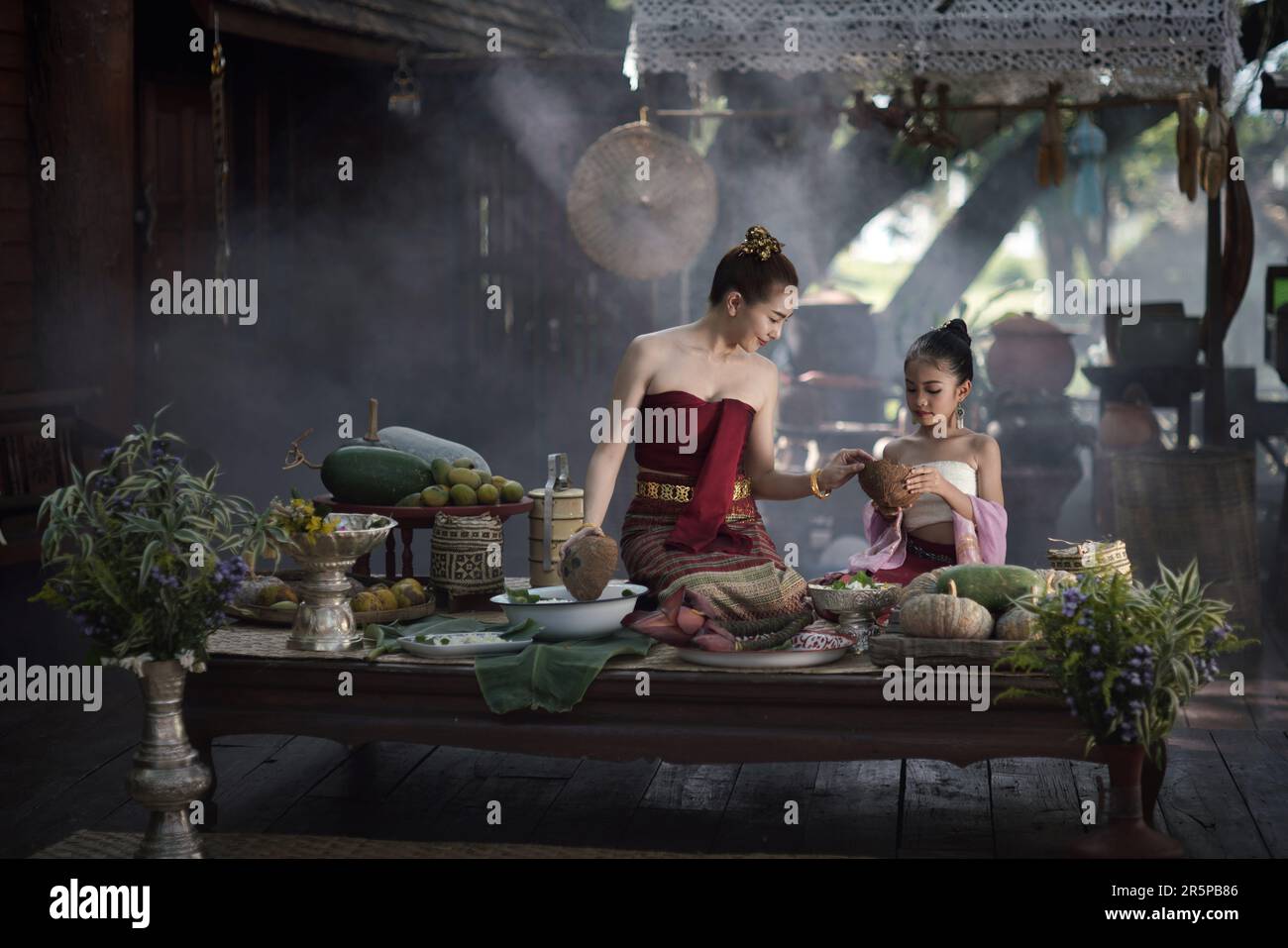 Thai Lanna traditionally dressed women in the Old Lanna house in Chiang ...