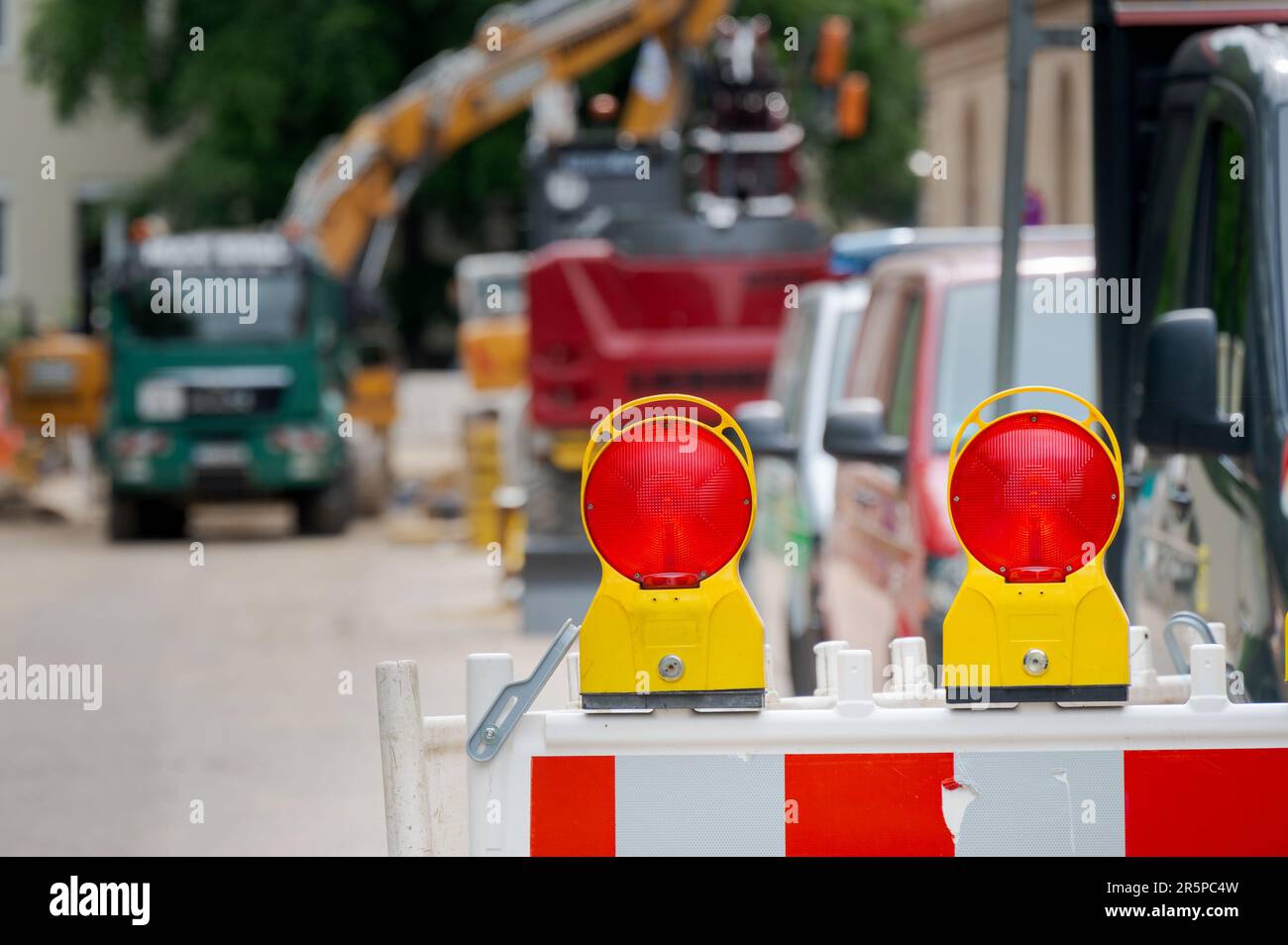 Two warning lamps mounted on roadblock at entrance to roadworks ...