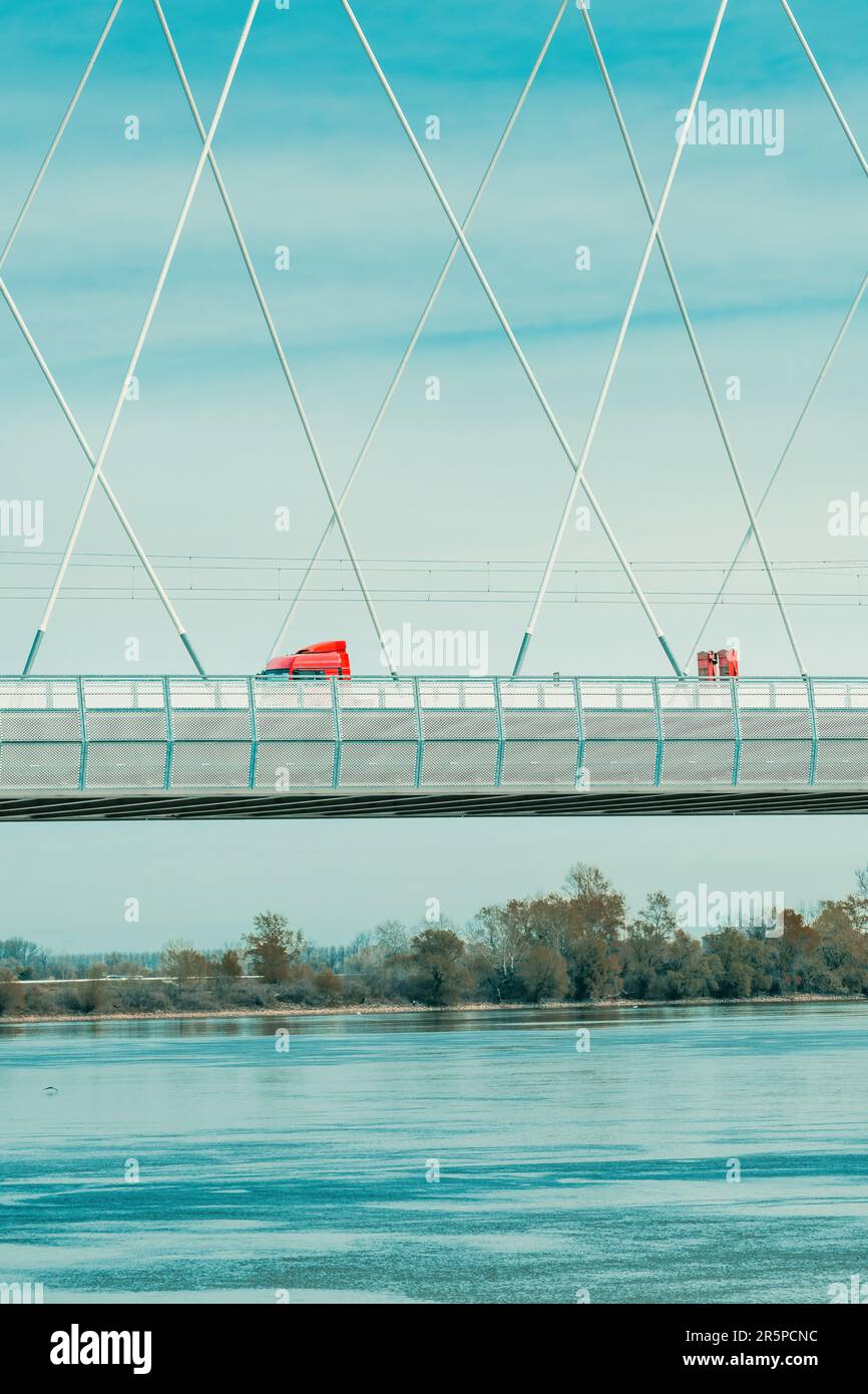 Red semi-truck crossing the bridge over Danube river in Novi Sad on ...