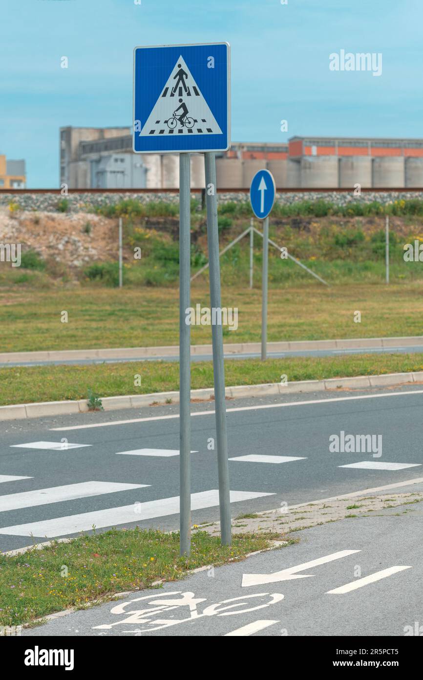 Pedestrian and cyclist crossing road traffic sign, selective focus ...