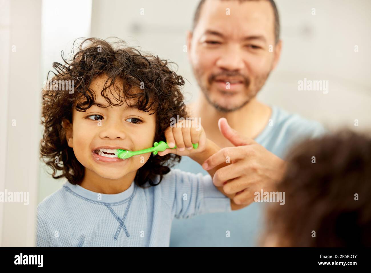 Child, brushing teeth and father learning in a bathroom with dental ...
